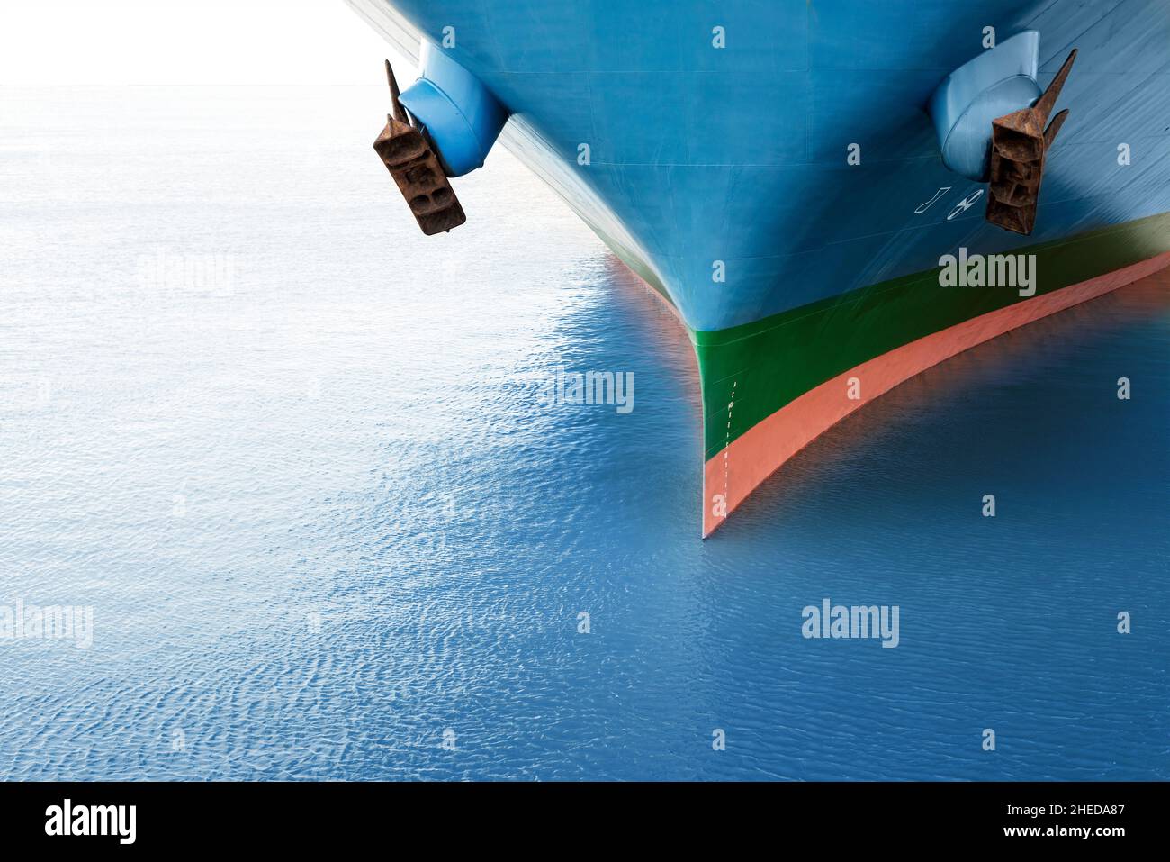 Front view of large blue merchant cargo ship in the middle of the ocean ...