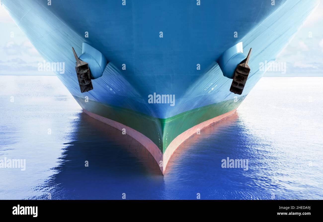 Front view of large blue merchant cargo ship in the middle of the ocean ...