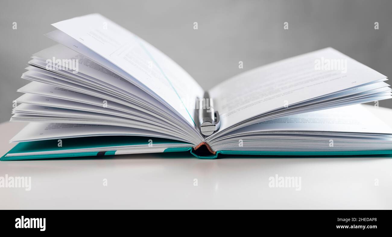 Open paper book with pages of business knowledge Stock Photo - Alamy