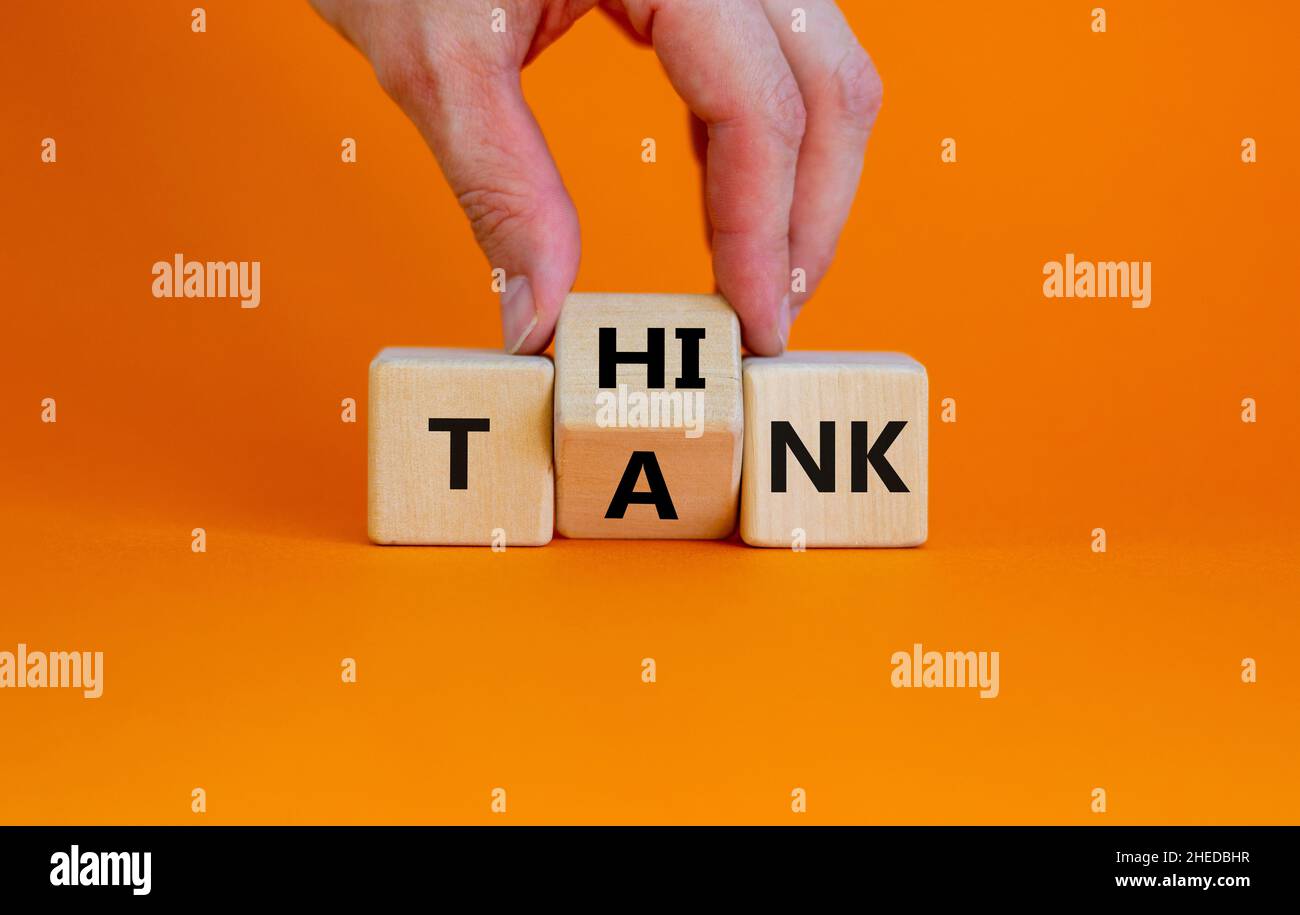 Think tank symbol. Businessman turns a wooden cube and changes the word ...