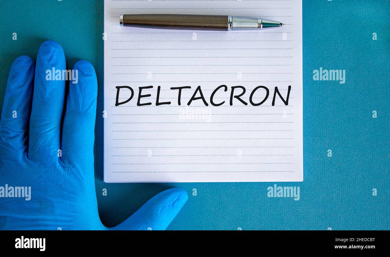 New covid-19 deltacron variant strain symbol. Hand in blue glove with ...