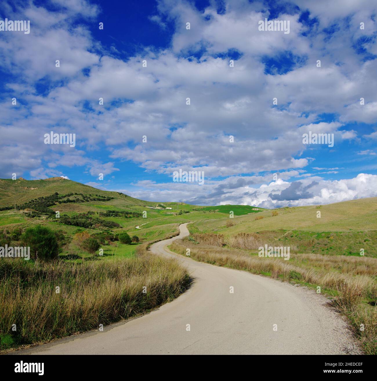 rural landscape in Sicily with winding road above cloudscape Stock ...