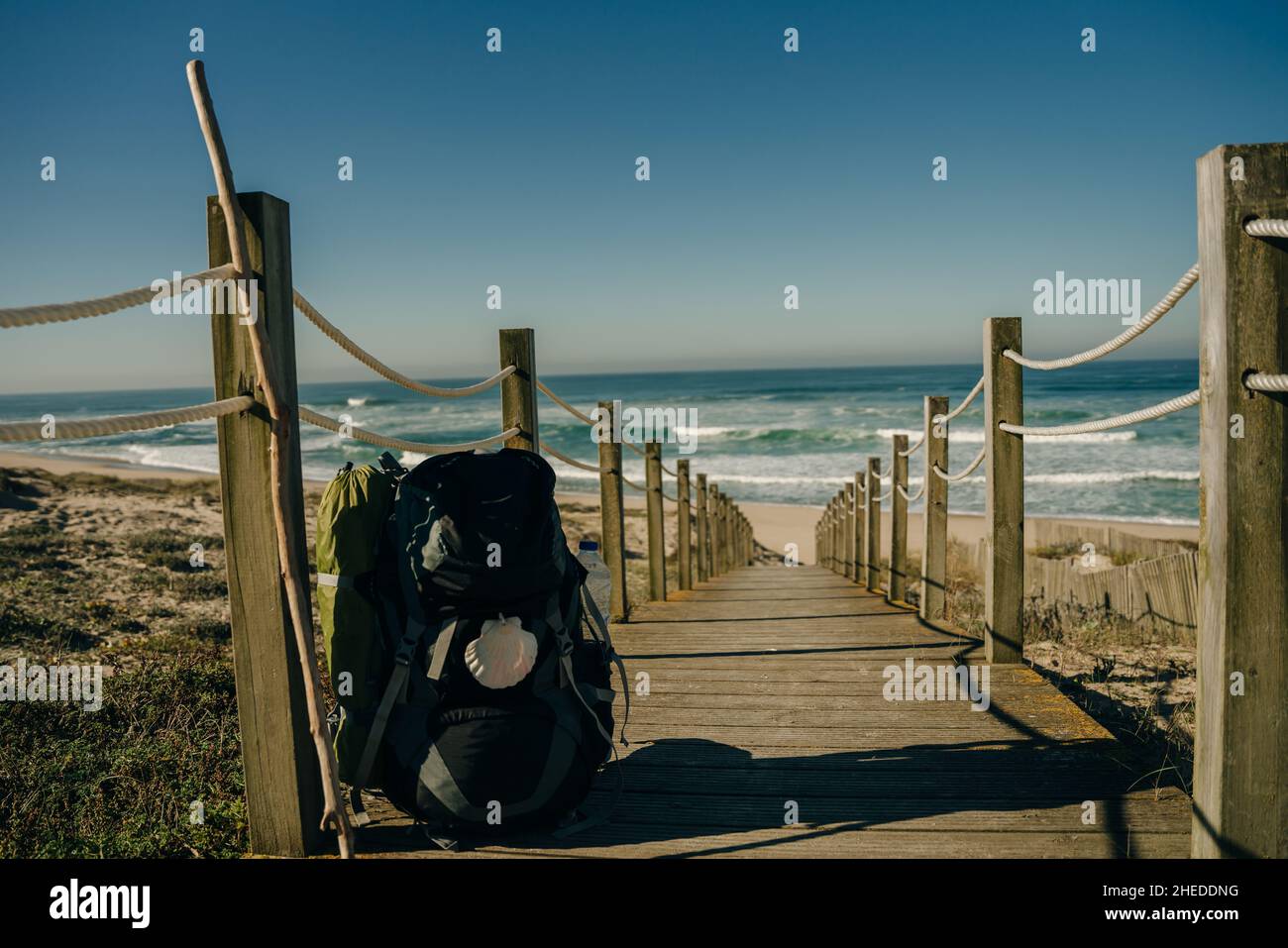 pilgrim's backpack with seashell on the beach Stock Photo - Alamy