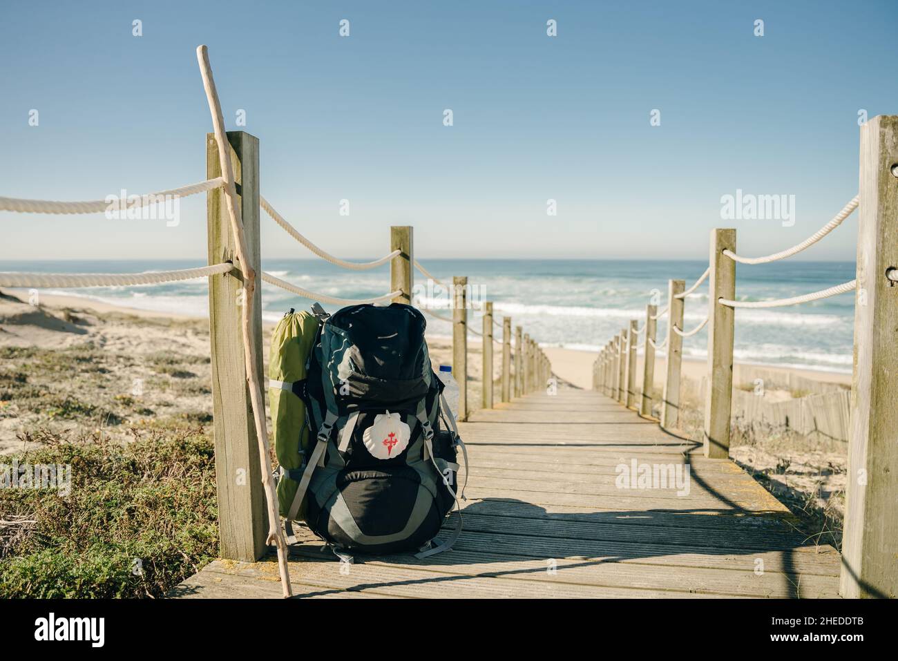 pilgrim's backpack with seashell on the beach Stock Photo - Alamy