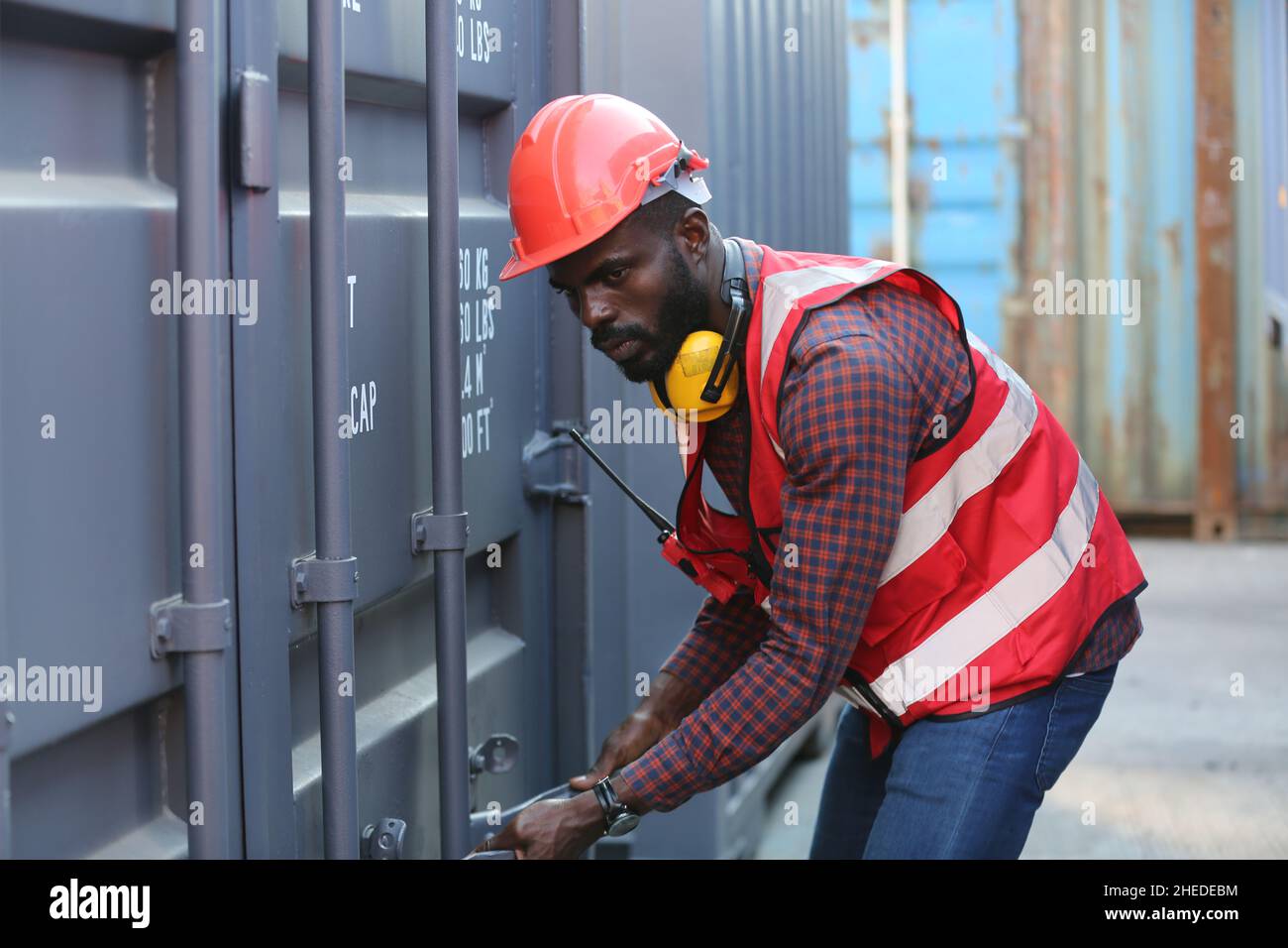 Foreman control loading Containers box from Cargo freight ship for ...