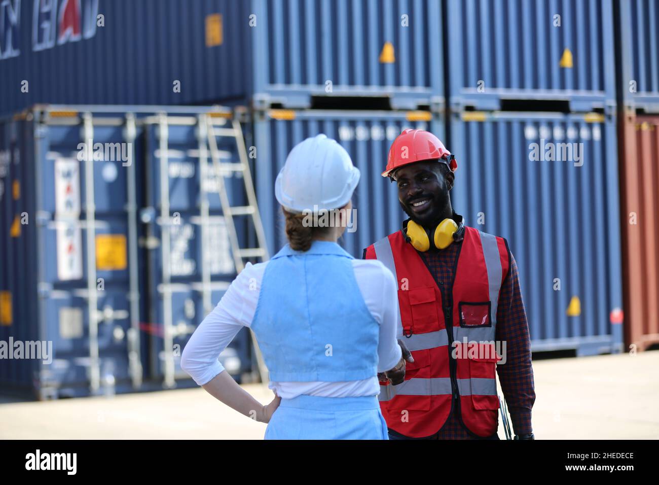 Foreman control loading Containers box from Cargo freight ship for ...