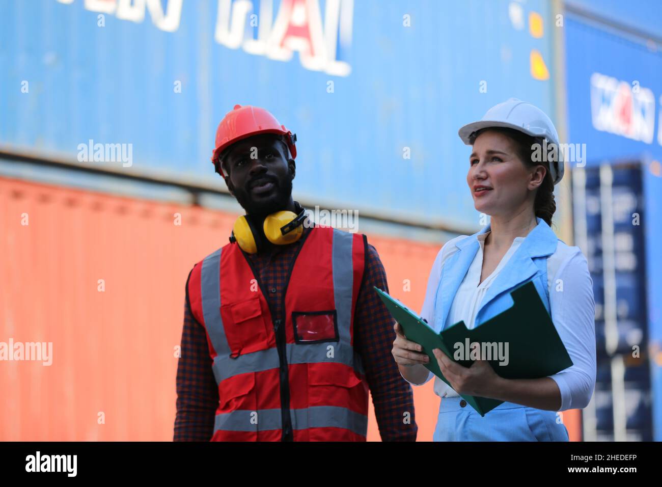 Foreman control loading Containers box from Cargo freight ship for ...