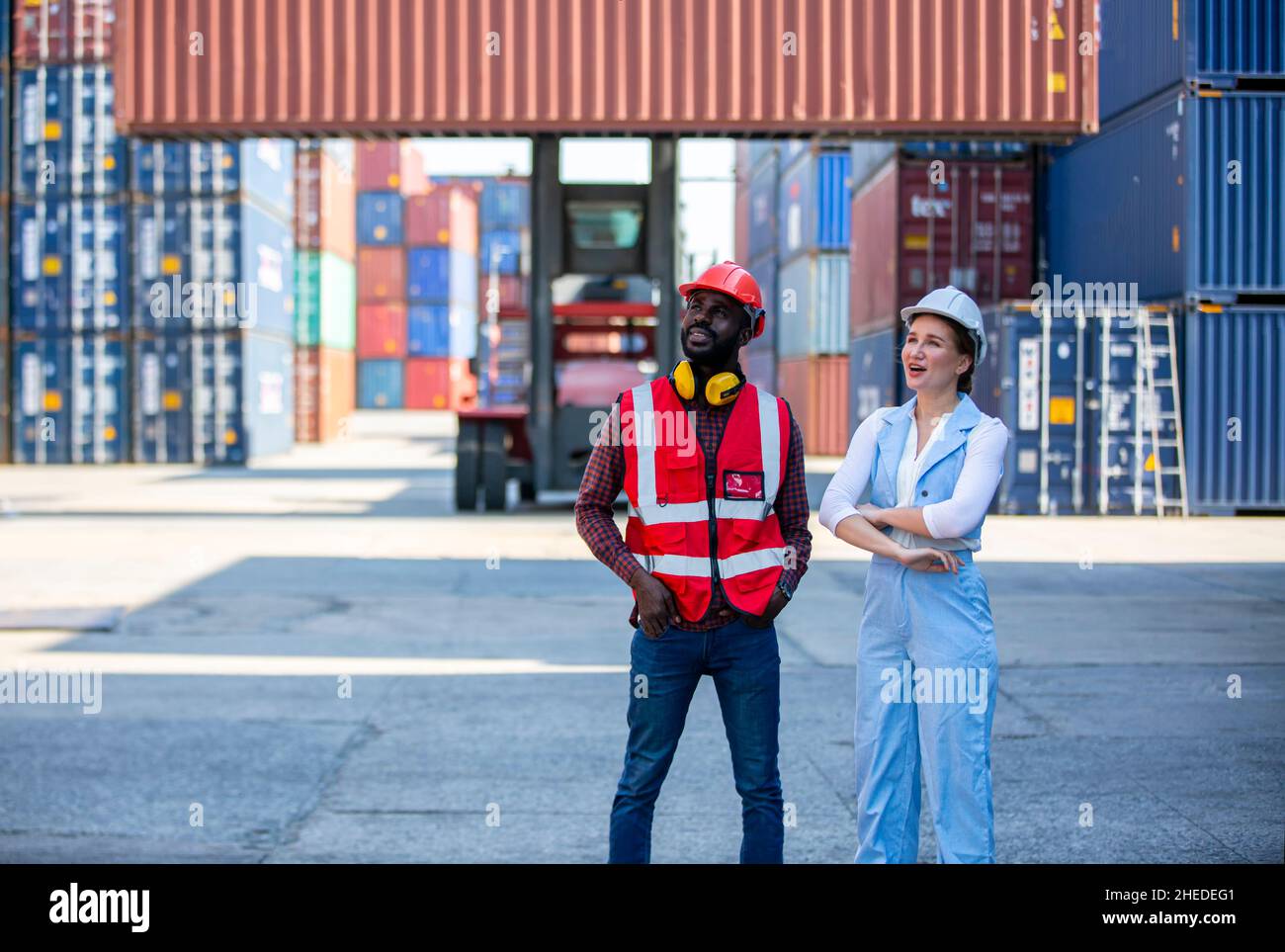 Foreman control loading Containers box from Cargo freight ship for ...
