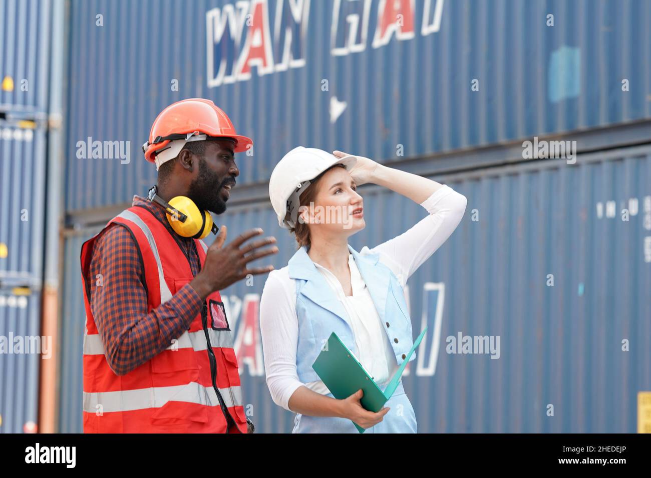 Foreman control loading Containers box from Cargo freight ship for ...