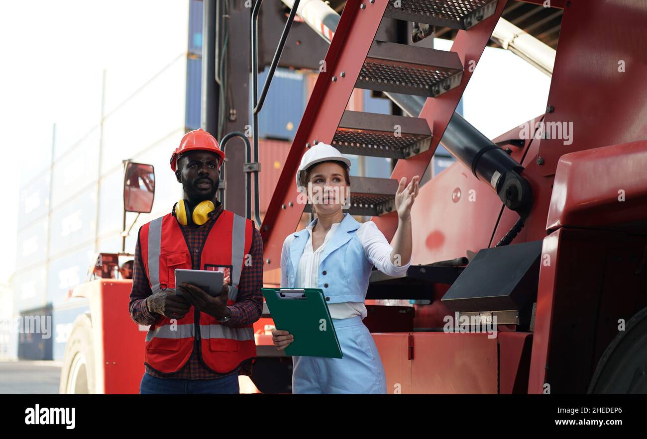 Foreman control loading Containers box from Cargo freight ship for ...