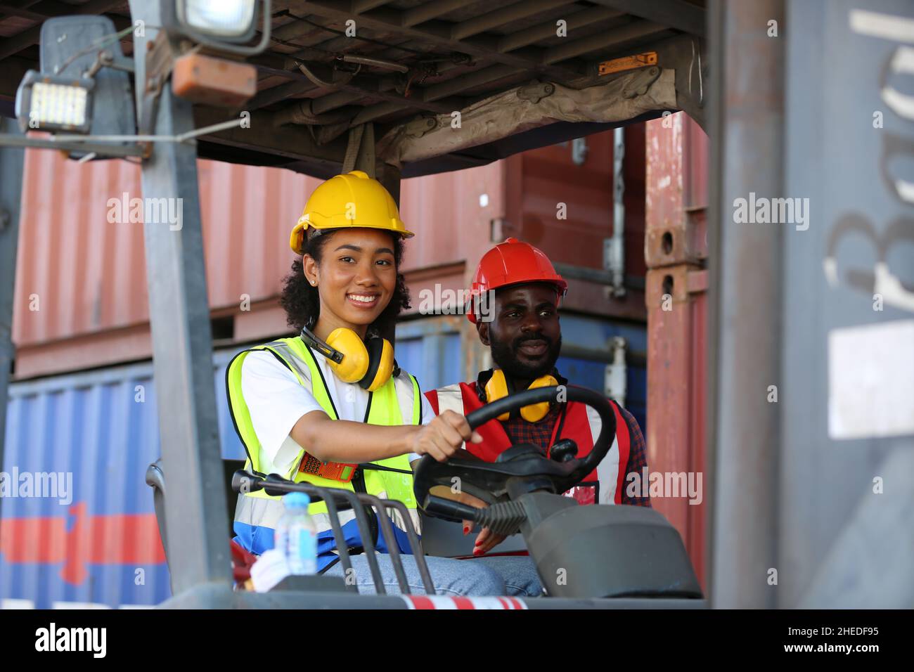 Foreman control loading Containers box from Cargo freight ship for ...