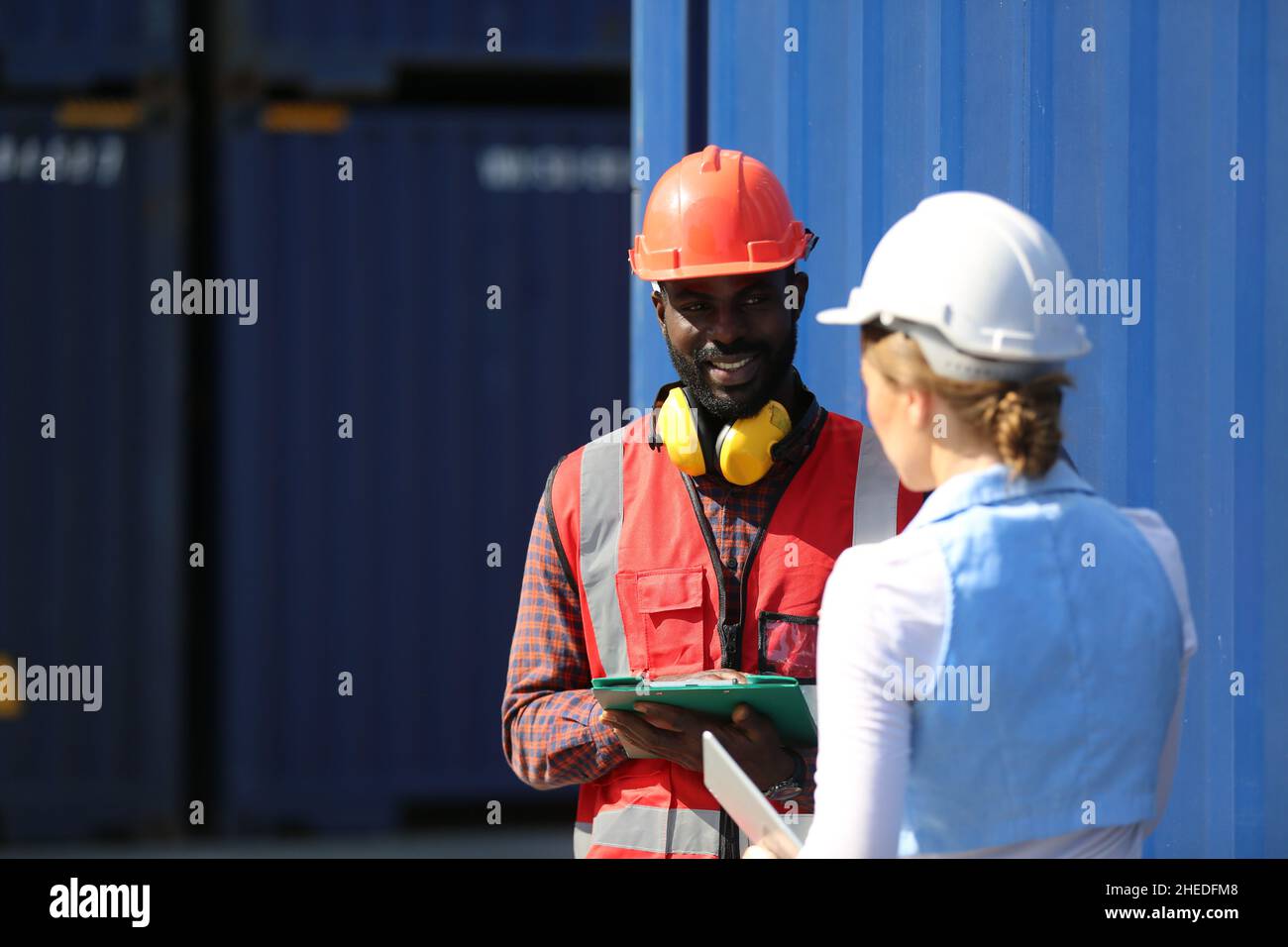 Foreman control loading Containers box from Cargo freight ship for ...