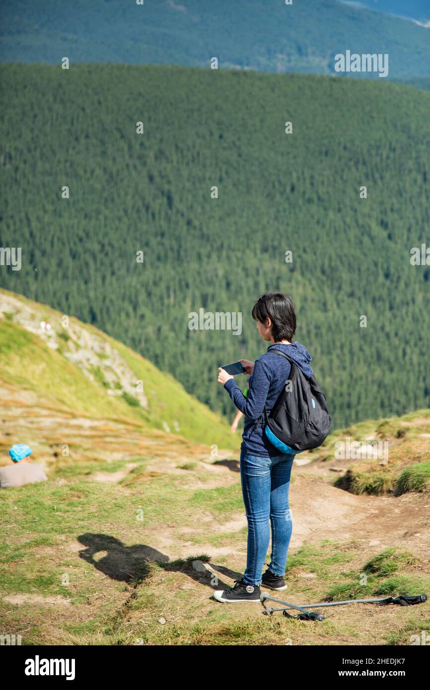 Girl Descend Down a Large Green Mountain Range Stock Photo - Alamy