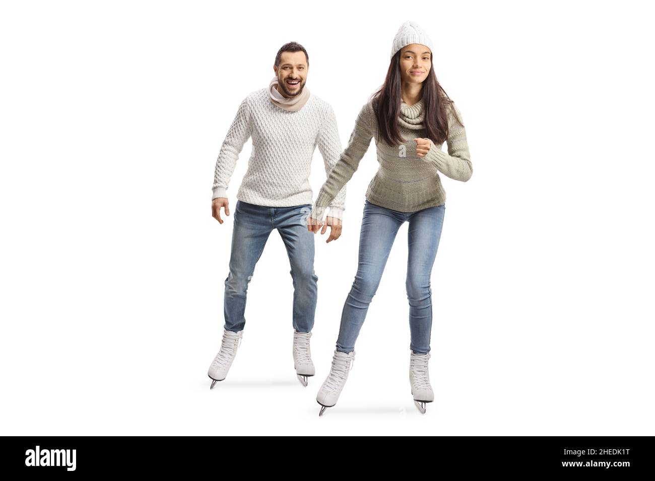 Full length portrait of a young casual man and woman ice skating ...