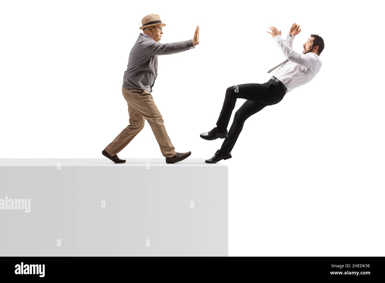 Full length profile shot of an elderly man pushing a young man from a ...