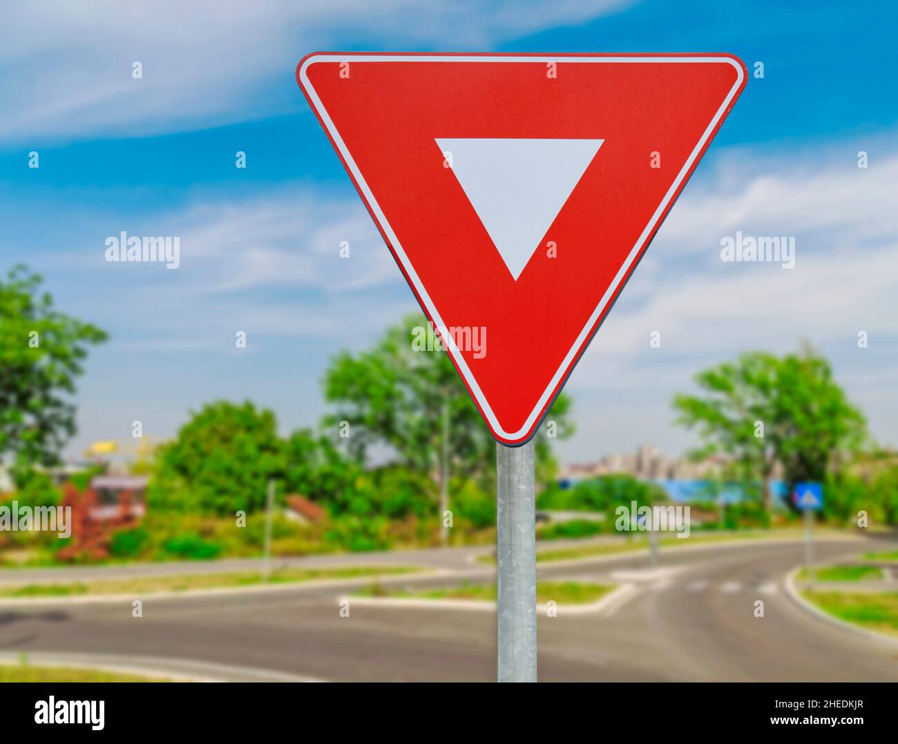 Red triangle road traffic coordination sign Stock Photo - Alamy