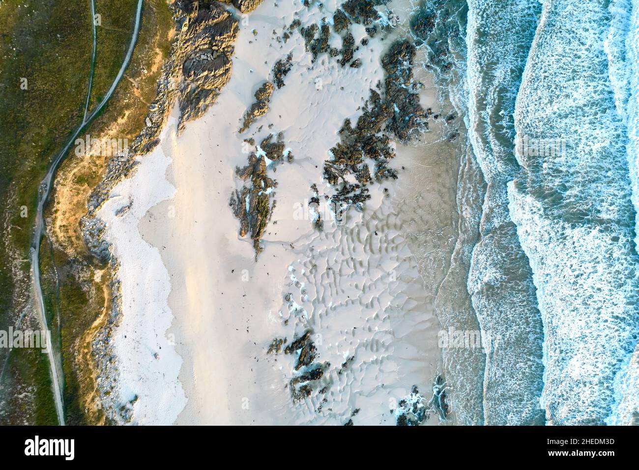 Hiking path on the rocky sandy beach at the water's edge from the sea ...