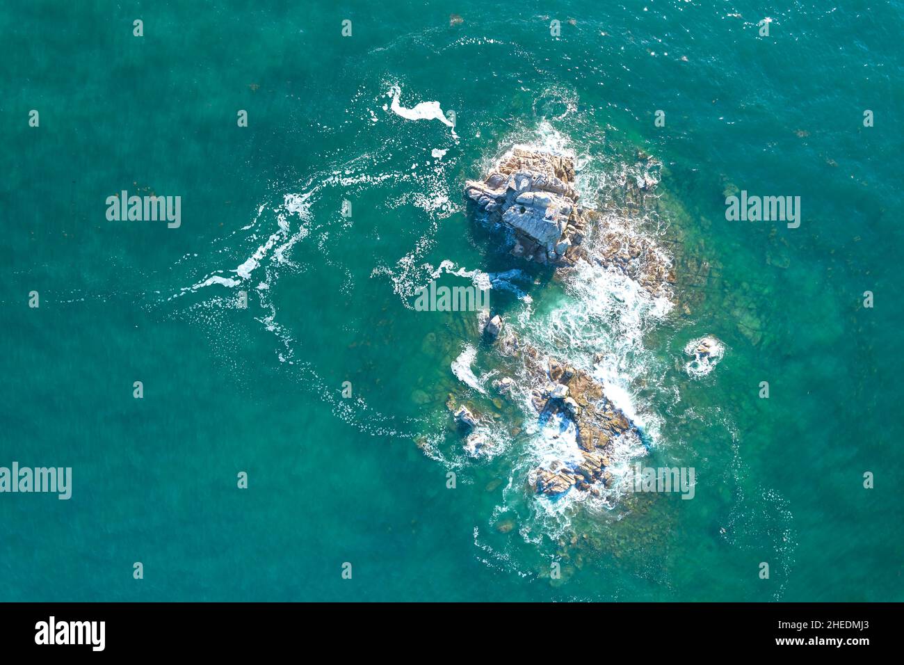 Small island from above. Aerial view of rocks in blue atlantic water ...