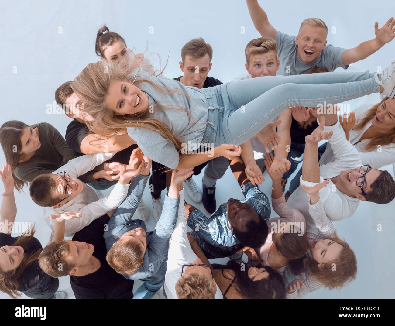 happy team of young people rocking their leader Stock Photo - Alamy