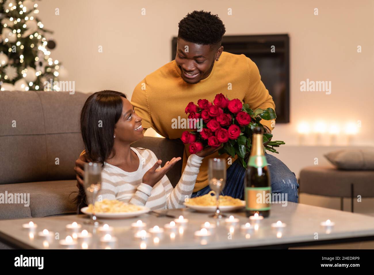 Black Boyfriend Giving Roses To Girlfriend On Valentine's Day Indoor ...