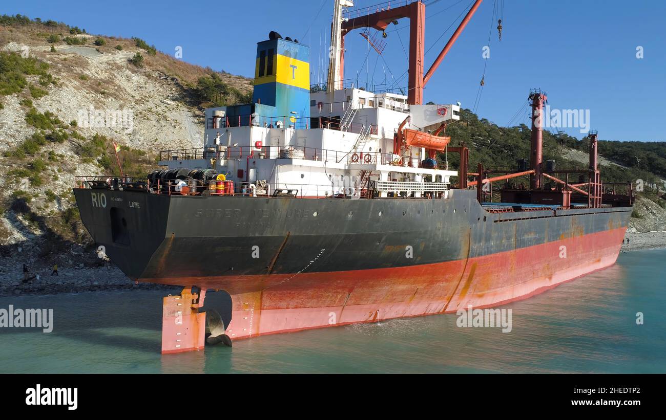 Aerial for an empty industrial ship moored near sea shore with many ...