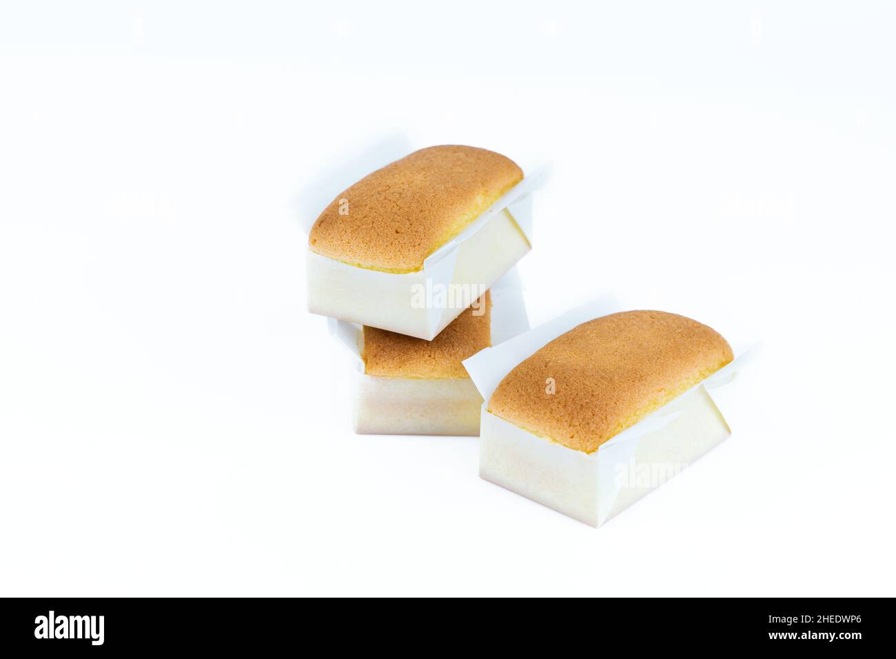 Three handmade madeleines in rectangular shape on white background ...