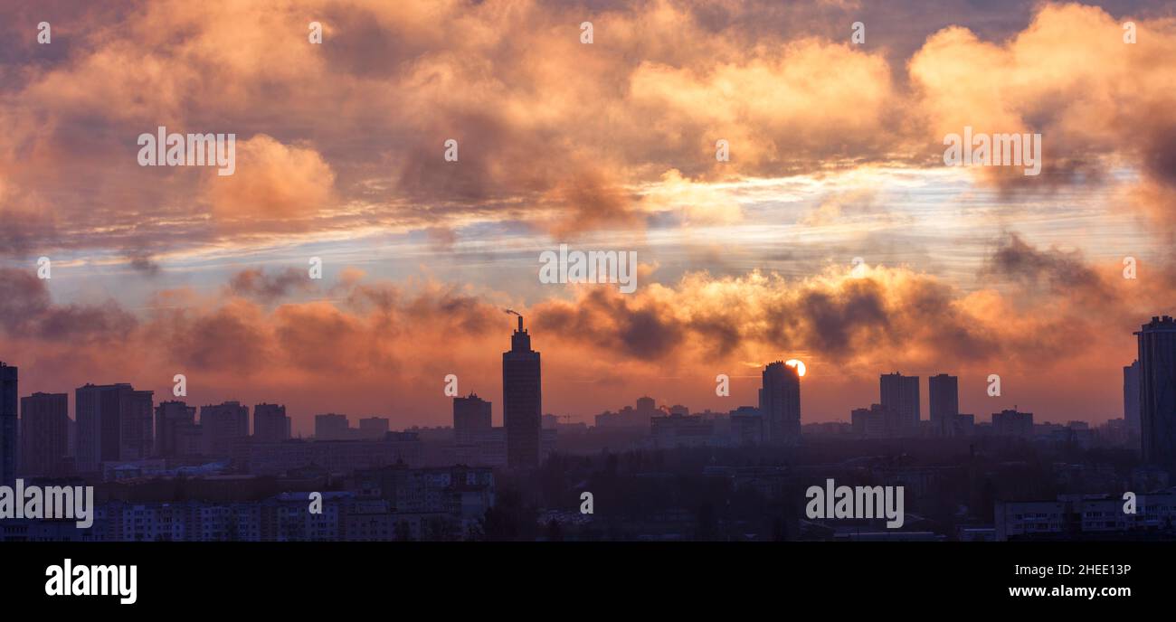 The rays of the rising sun break through the smoky smog above the ...