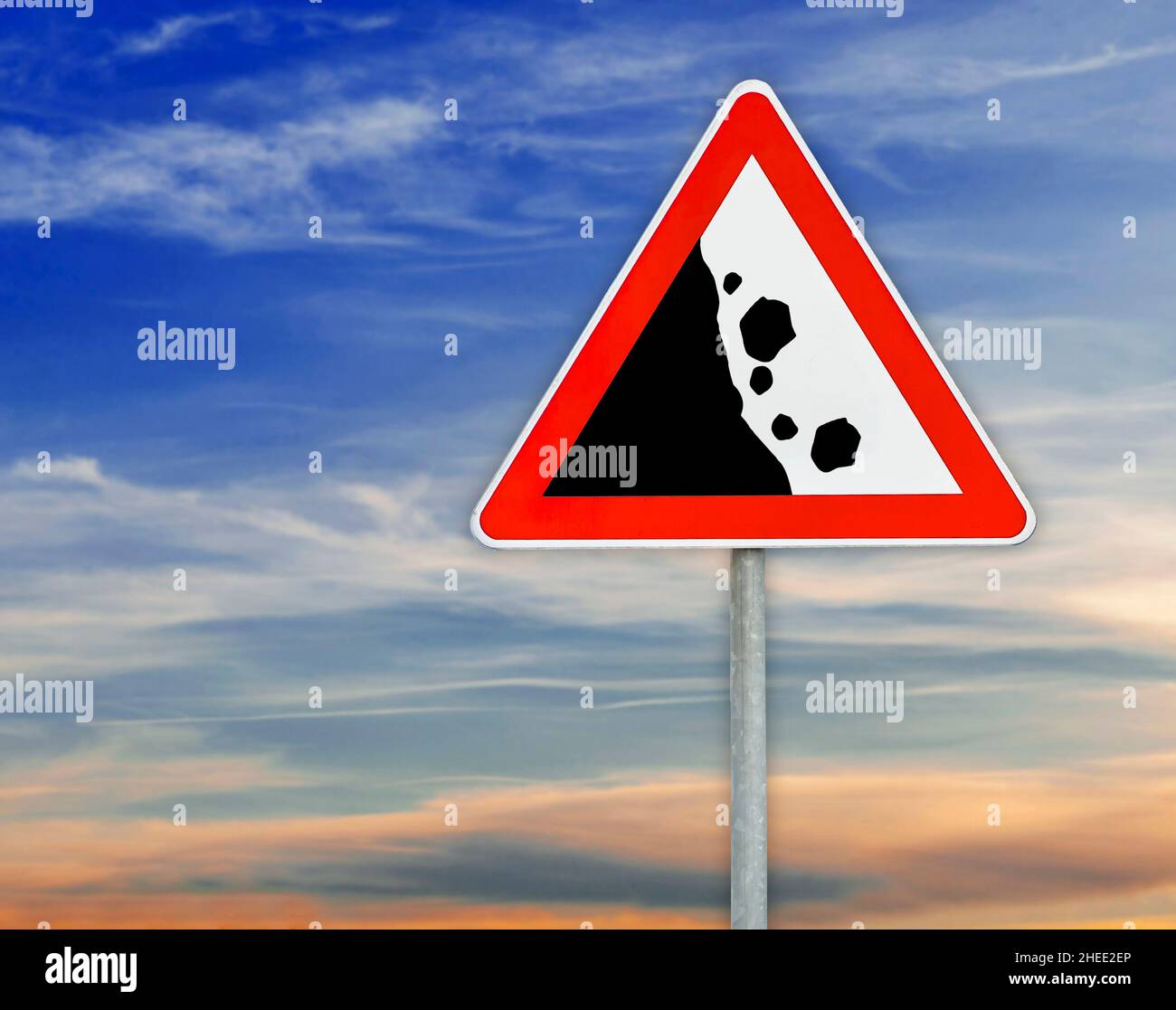 Triangle road sign falling rocks on rod Stock Photo - Alamy