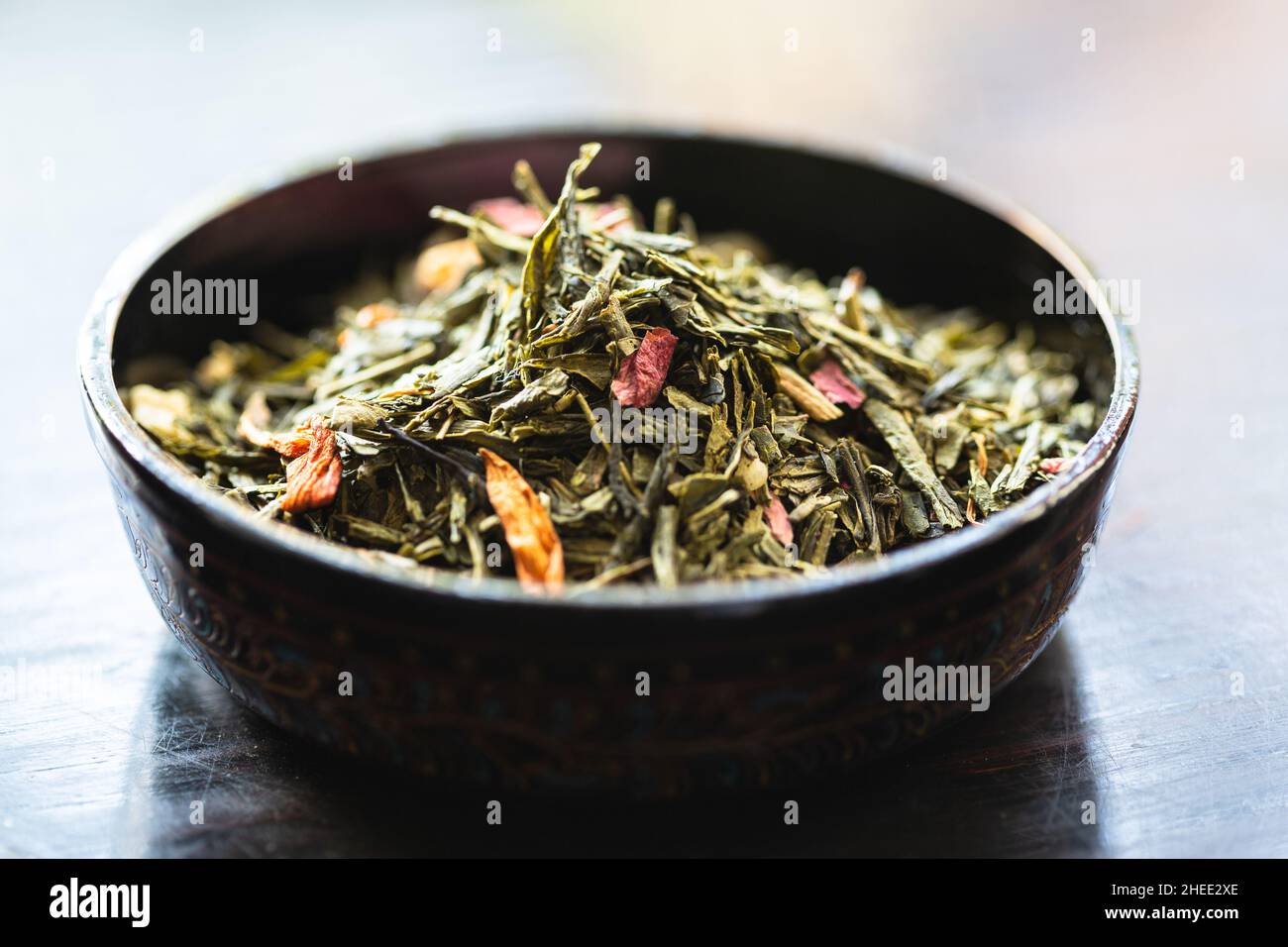 Green tea leaves with flowers petals Stock Photo - Alamy