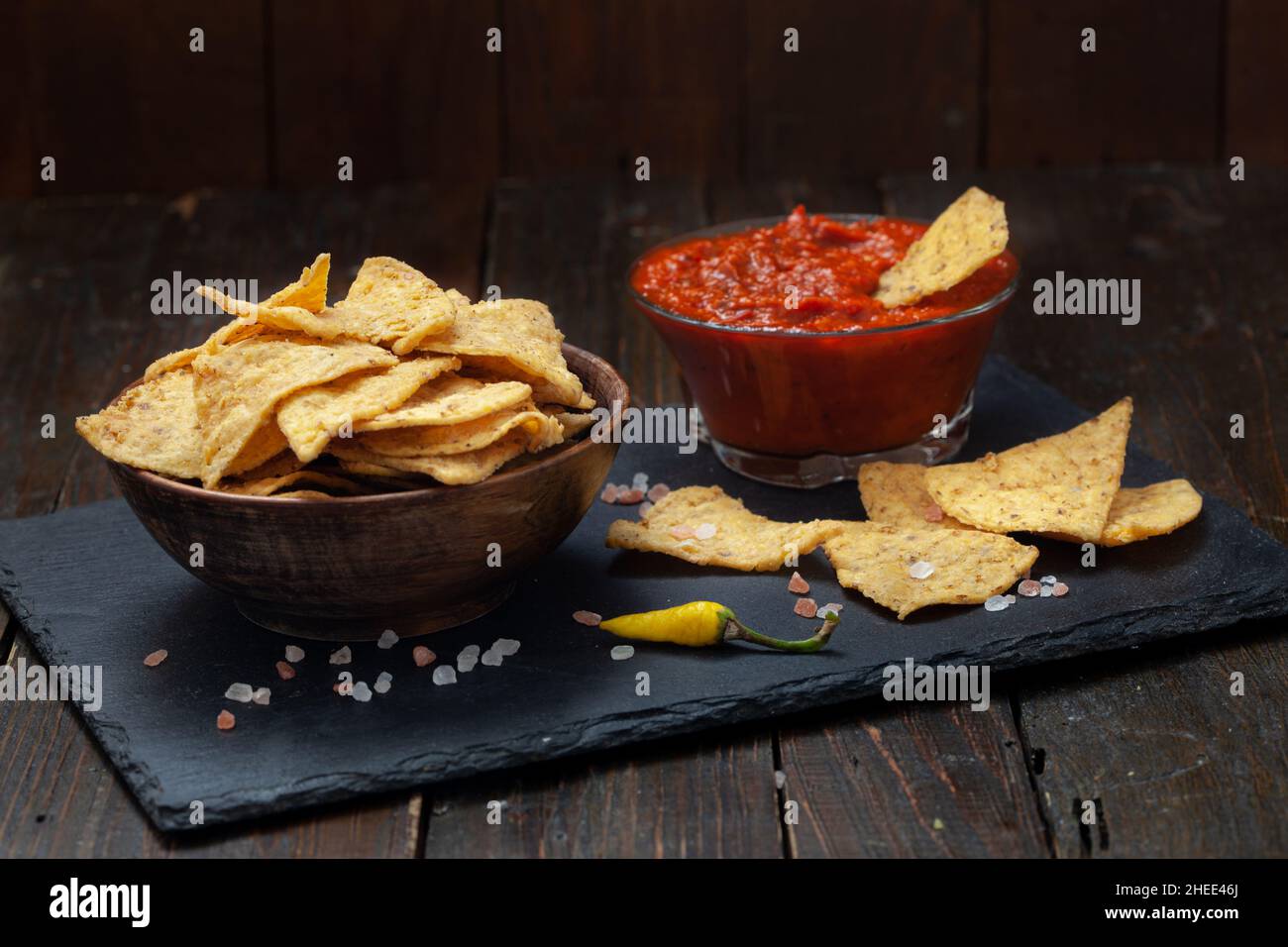 Mexican corn chips nachos with salsa dip. Crispy nachos with spicy red ...