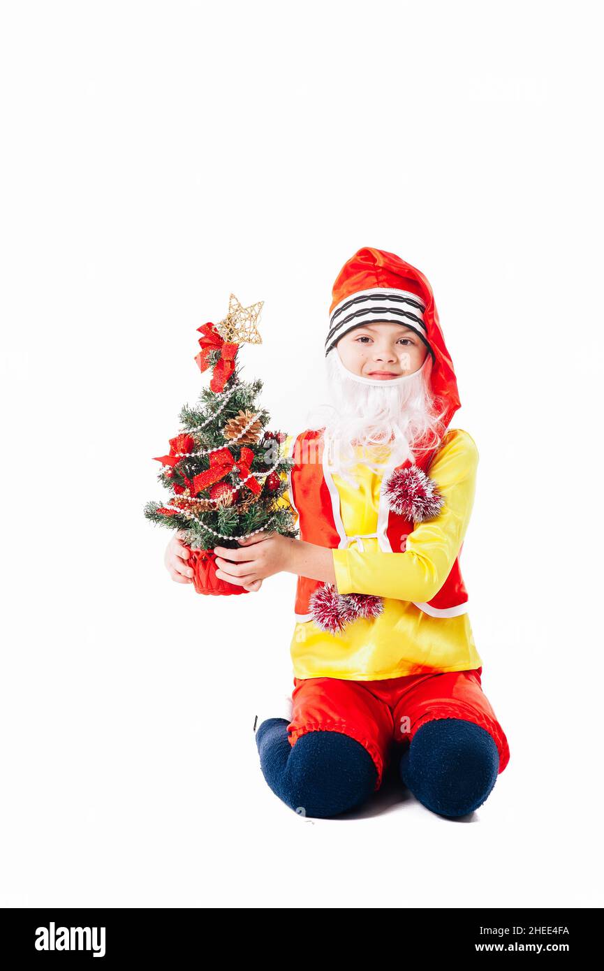 A baby dressed as a elf. isolated. Santa's helper. boy in suit of dwarf ...