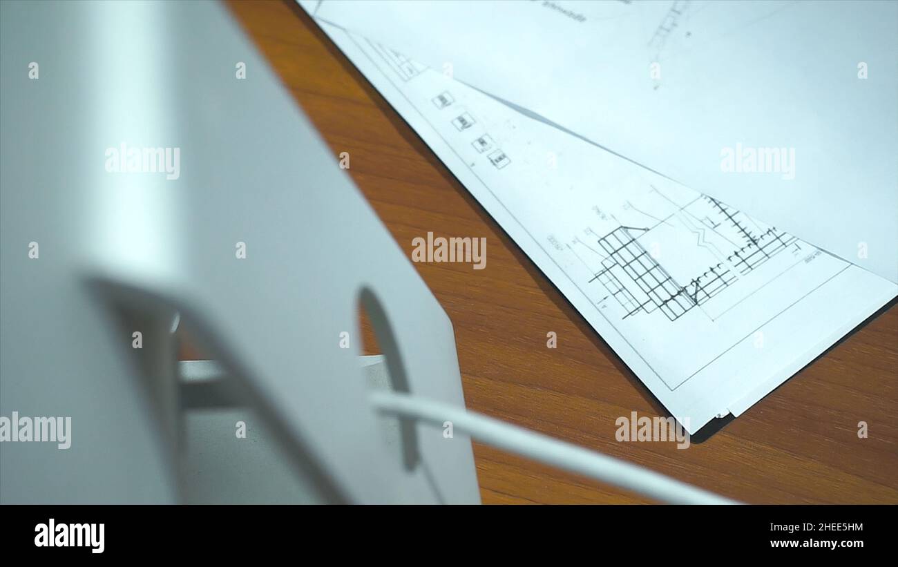 overhead view of architect's desk with blueprints and computer. Top ...