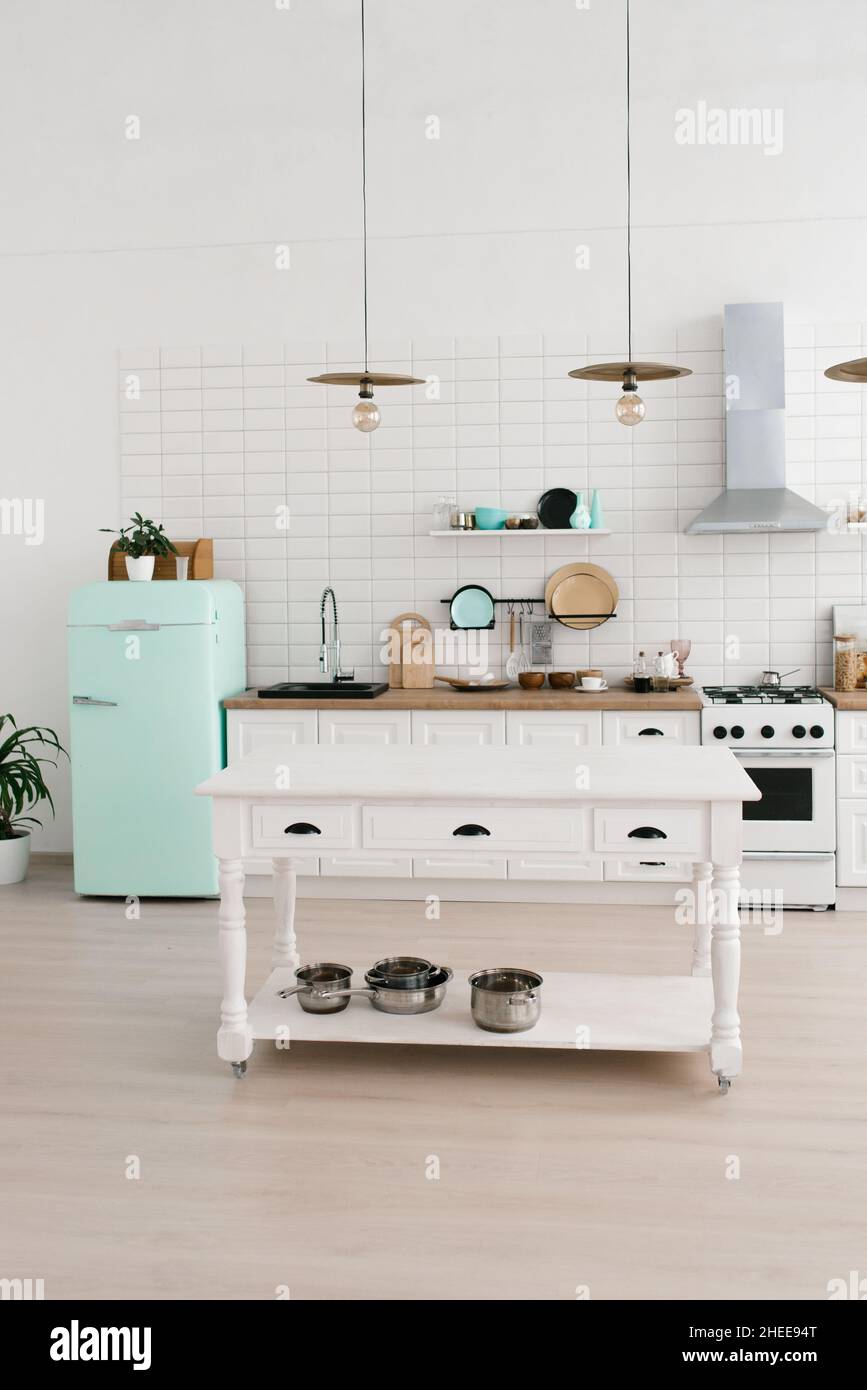 Bright Scandinavian-style kitchen with mint-colored refrigerator Stock ...