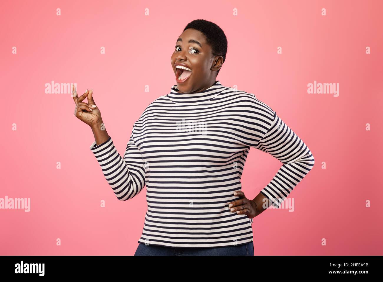 Joyful Plus-Sized African American Female Snapping Fingers Over Pink ...