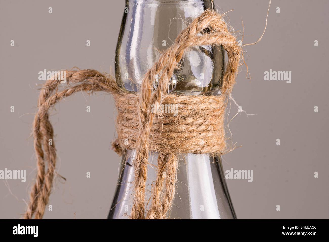 bast rope around a bottle neck Stock Photo - Alamy