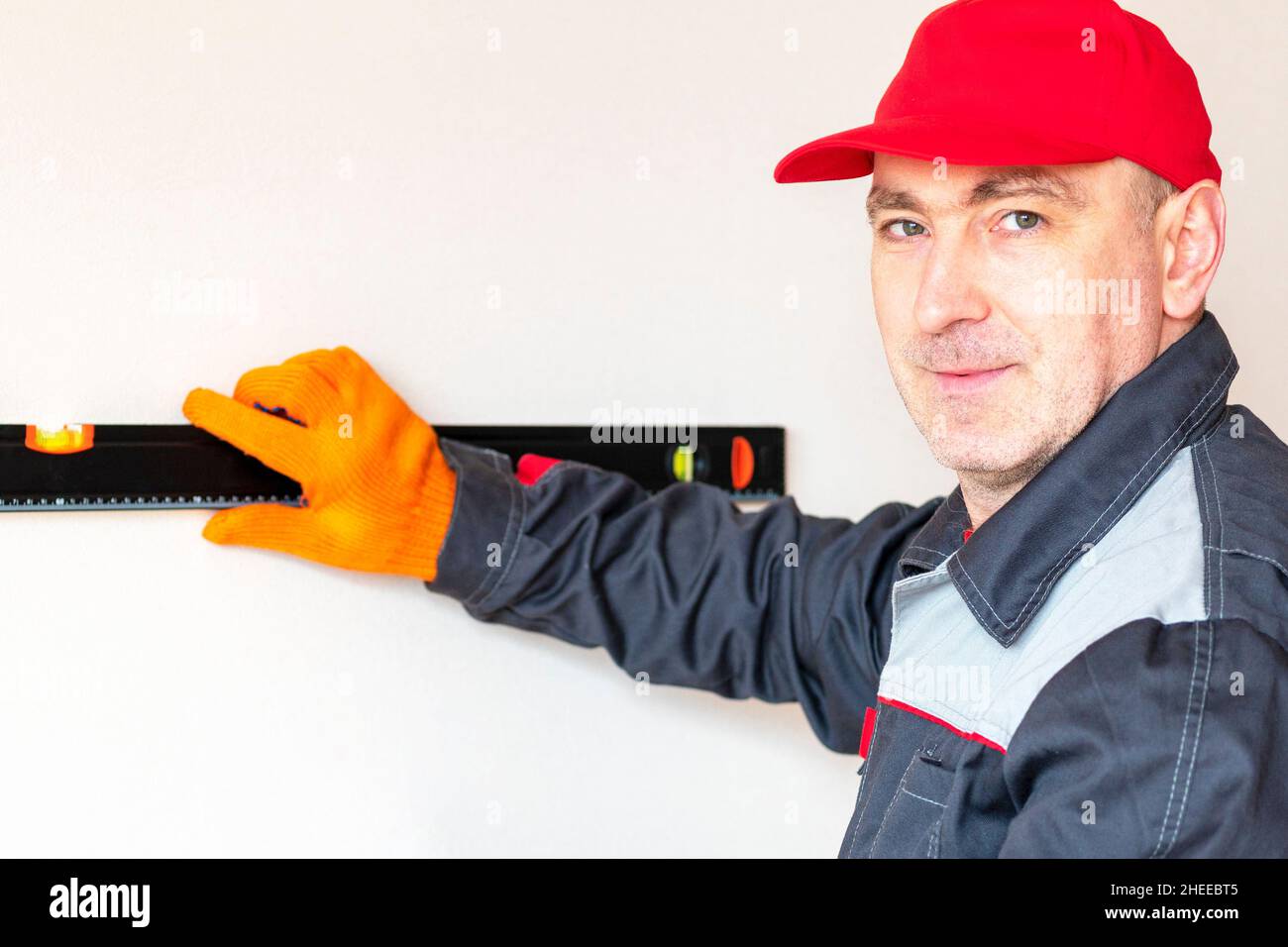 Worker with bubble level. measuring with bubble level.Measurement ...