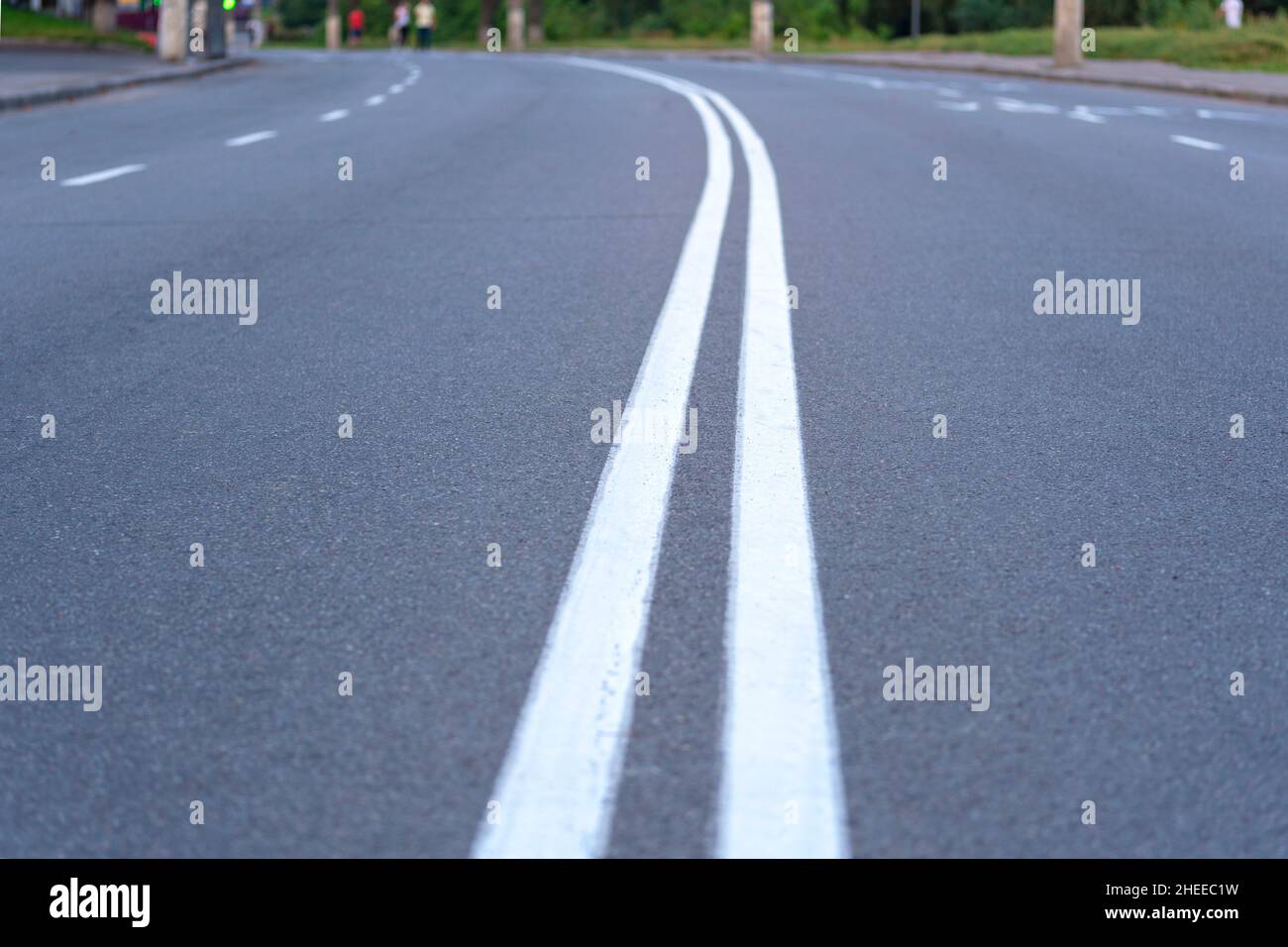 The asphalted road with two continuous white strips. The highway with a ...