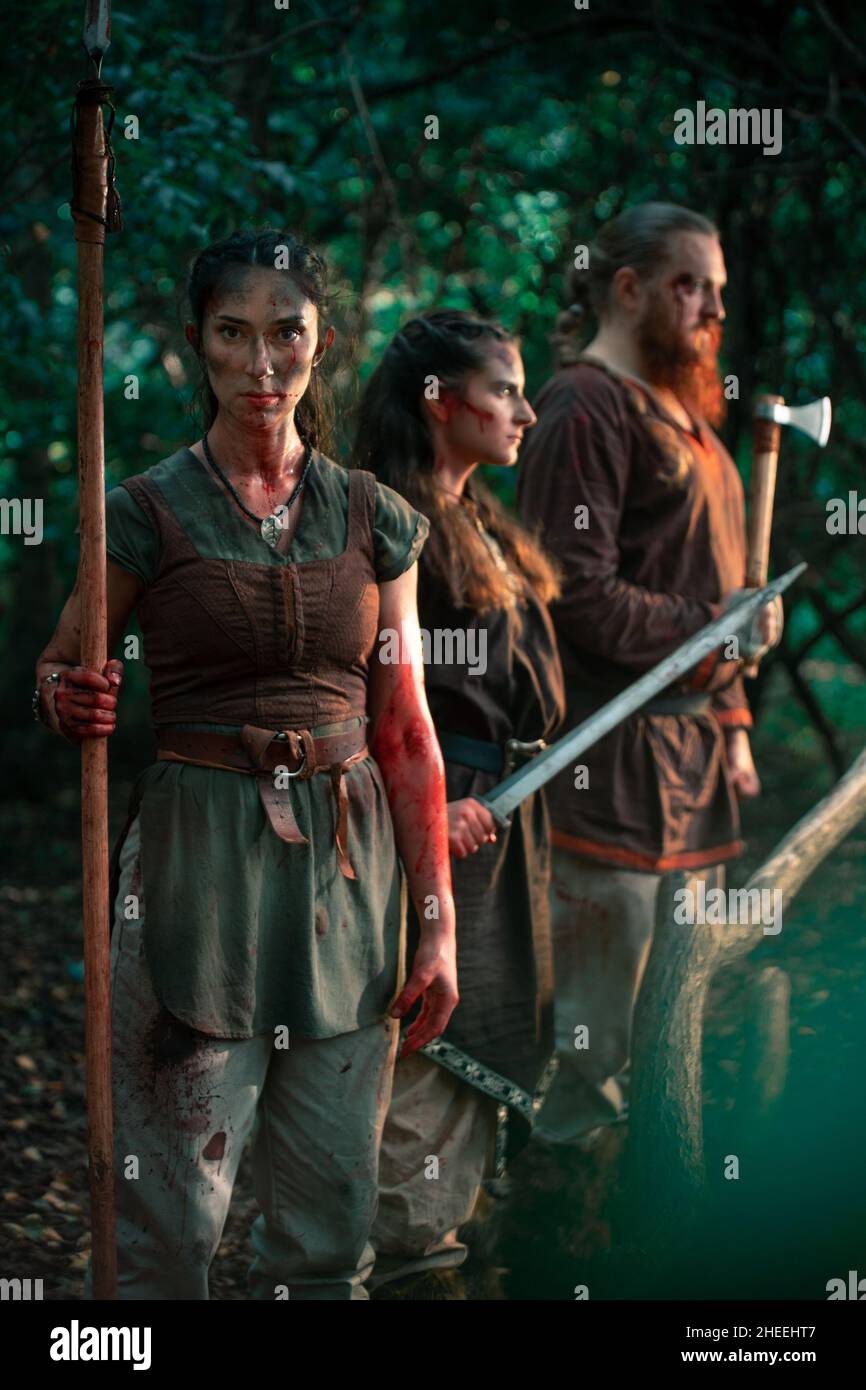 Male and females injured warriors with axe sword and spear for fight ...