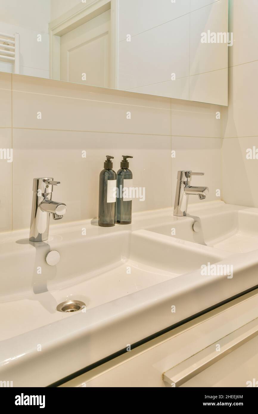 Interior design of contemporary bathroom with double washbasins with ...