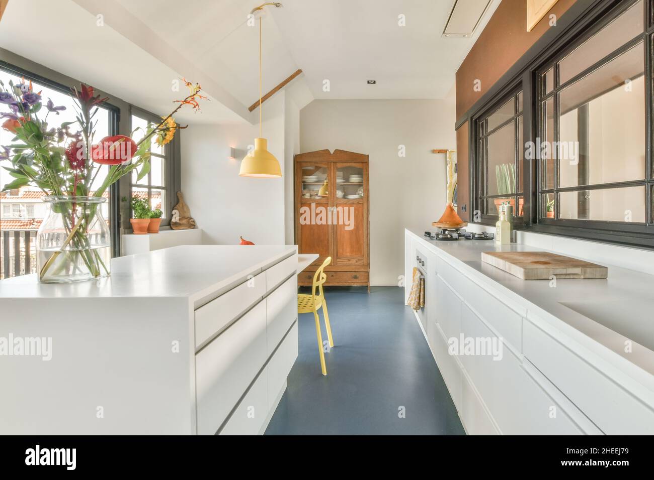 Interior of contemporary kitchen with dining table surrounded with ...