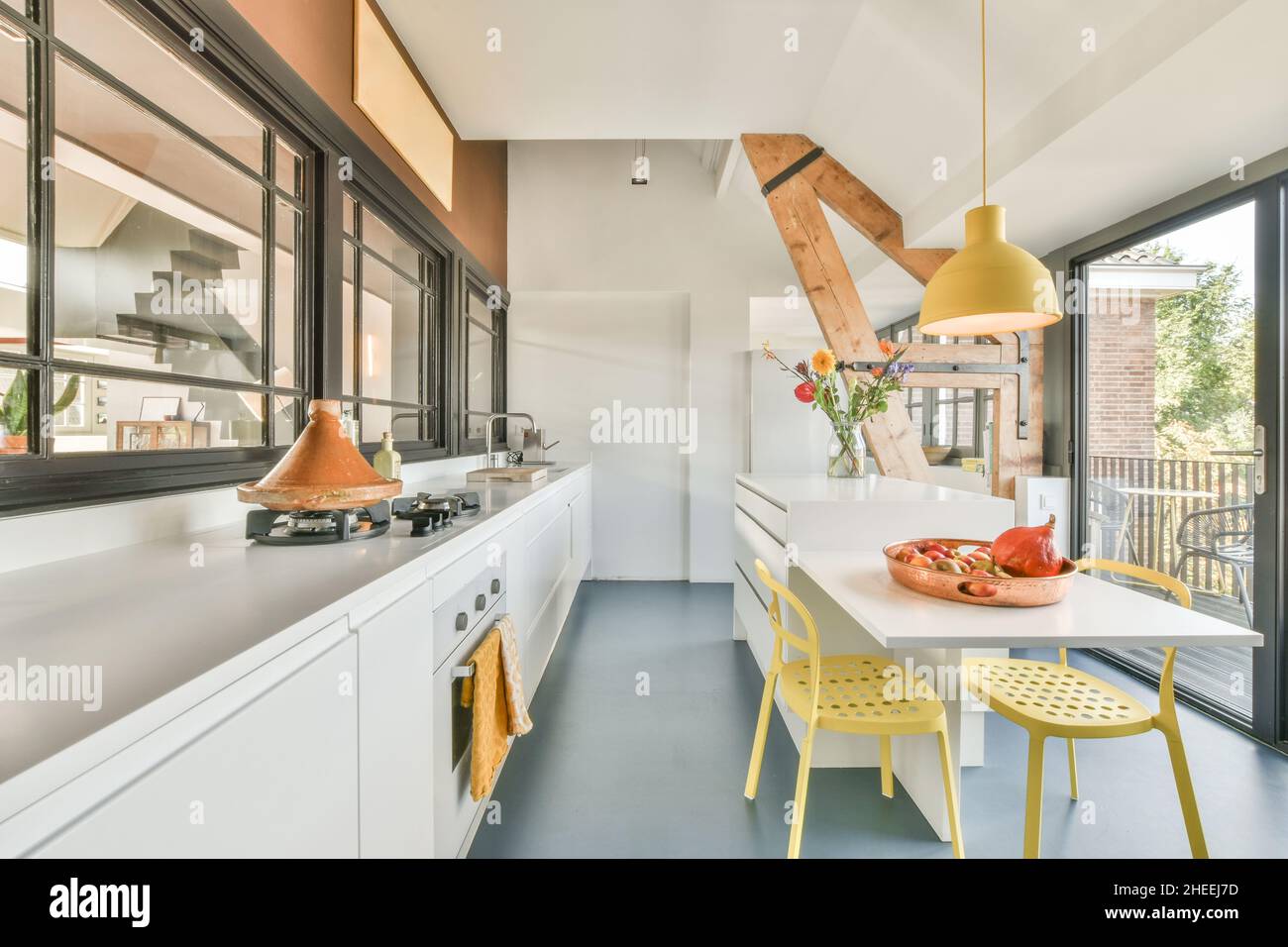 Interior of contemporary kitchen with dining table surrounded with ...