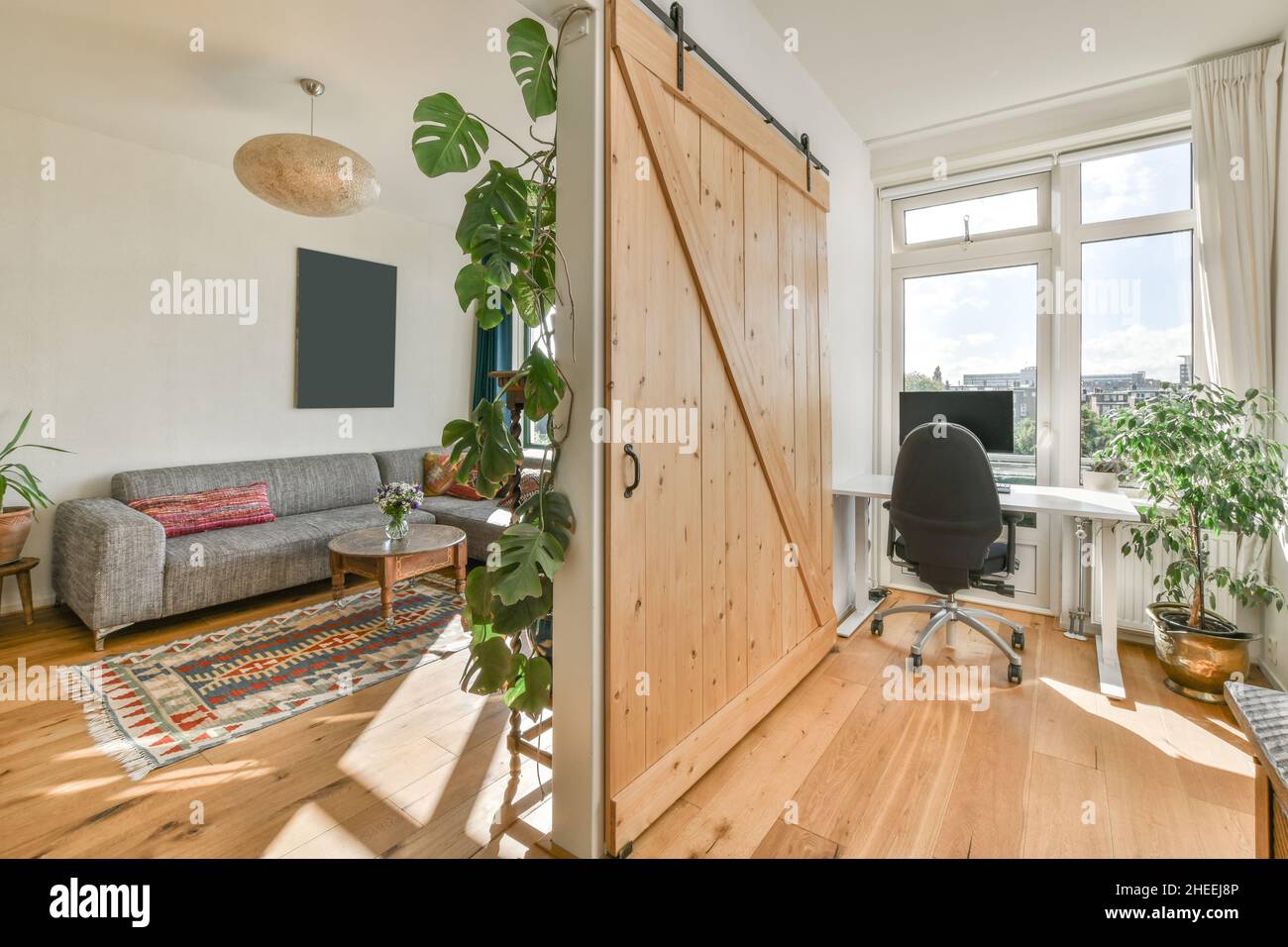Interior of workroom with chair and table placed at window and living ...