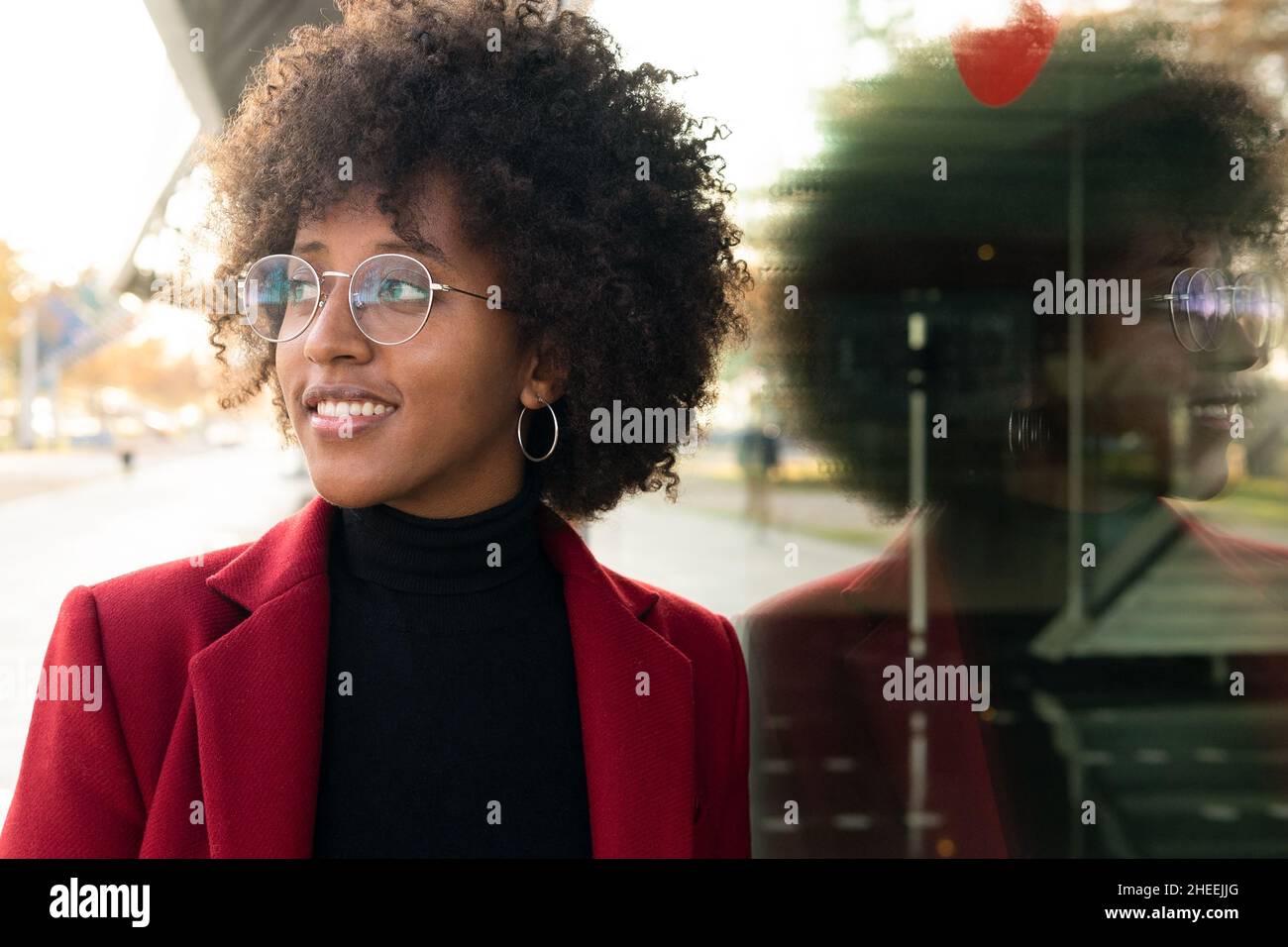Delighted African American female with Afro hairstyle wearing ...