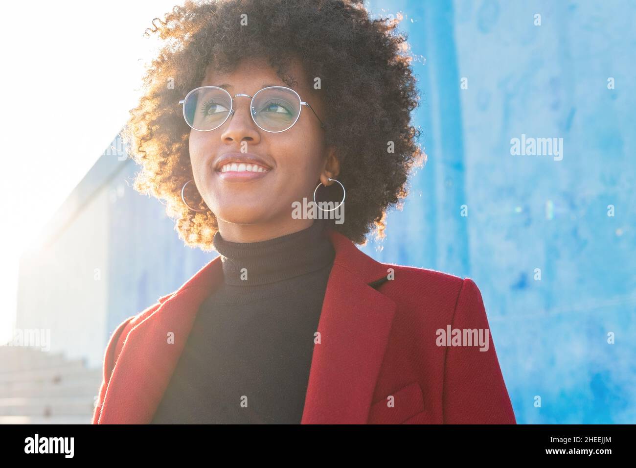 From below of smiling black female with Afro hairstyle standing near ...
