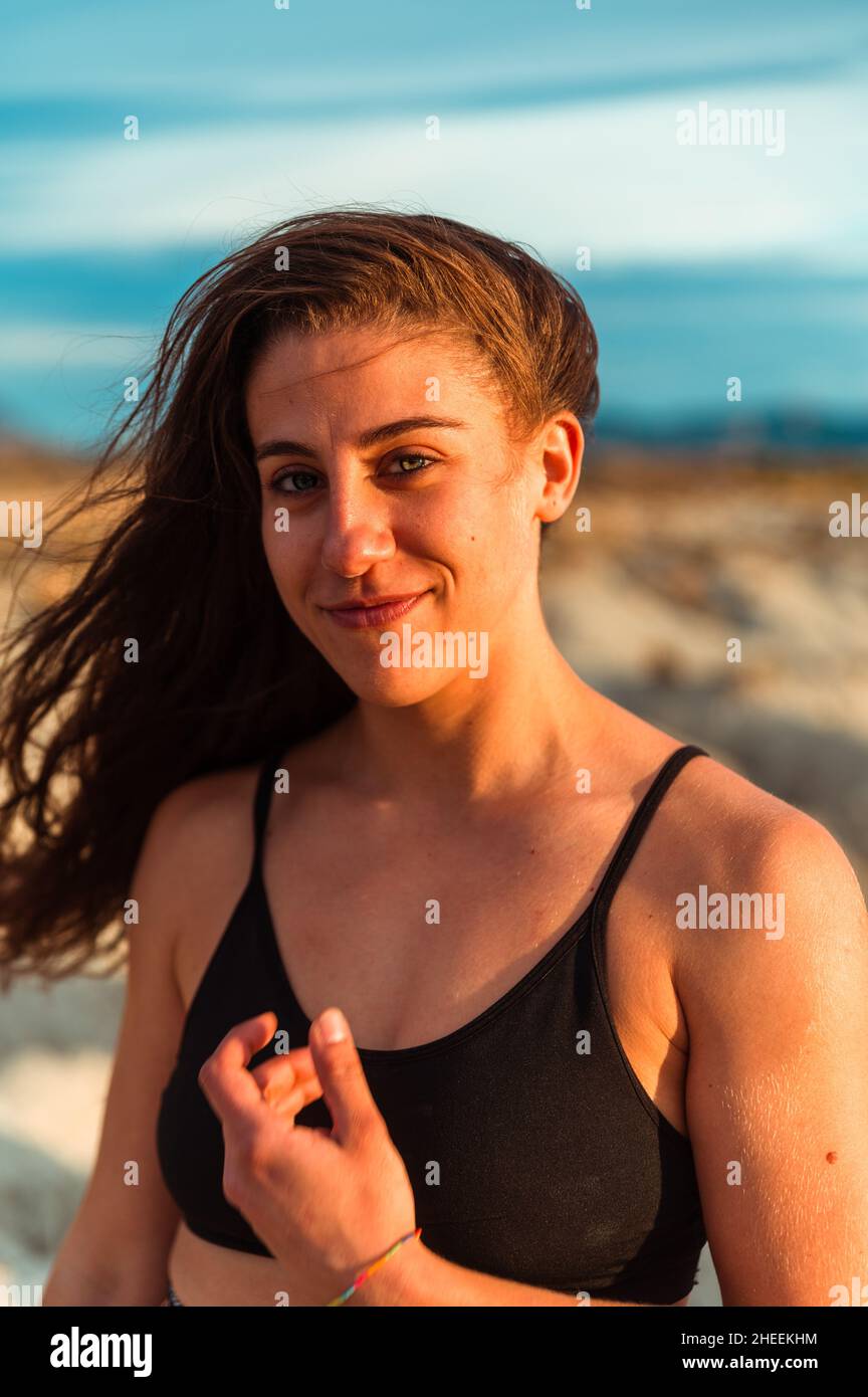 Attractive Positive Woman Brunette With Waving Long Hair And Wearing