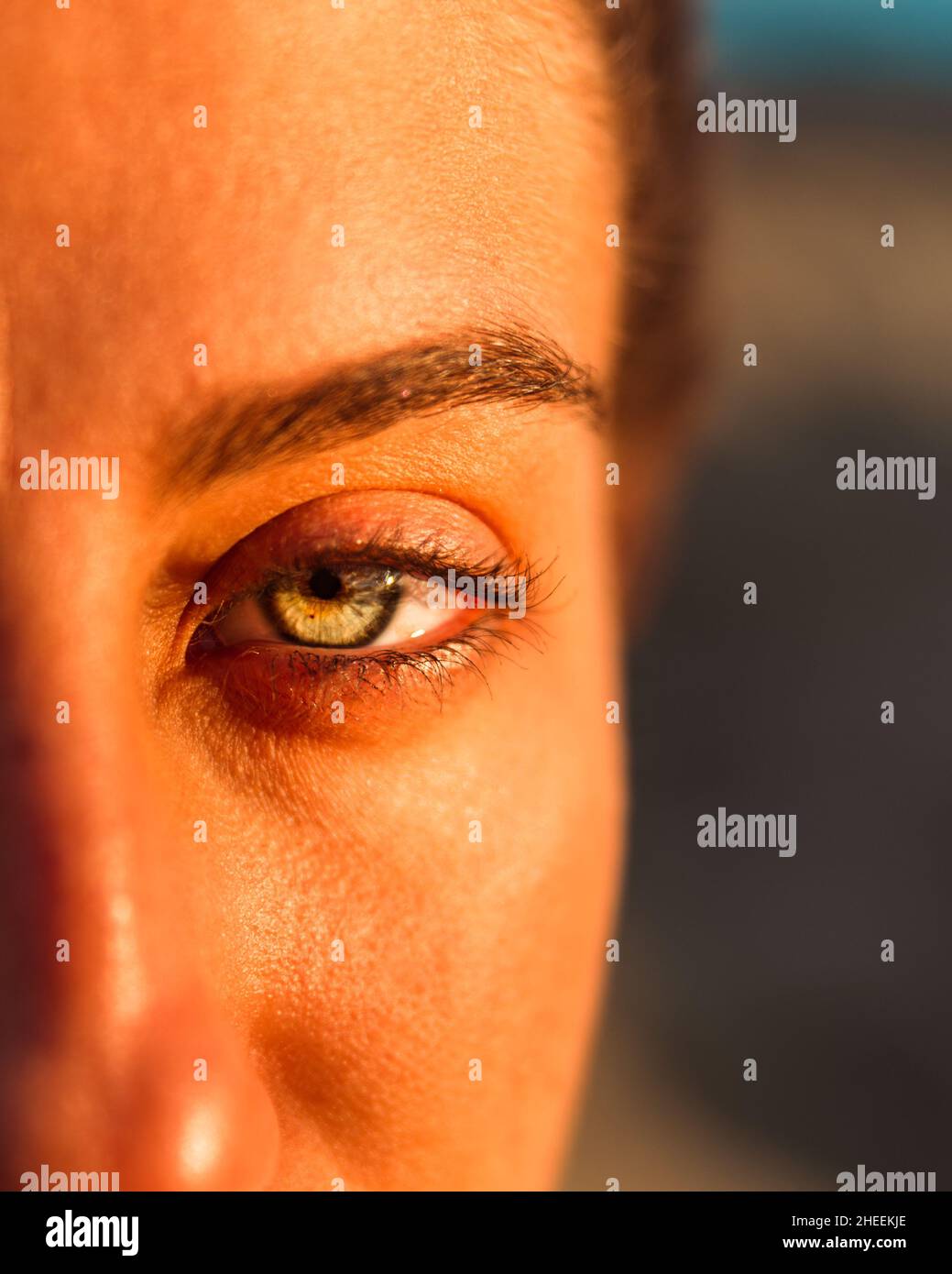 Closeup of crop half face of young Woman with light green eyes looking ...