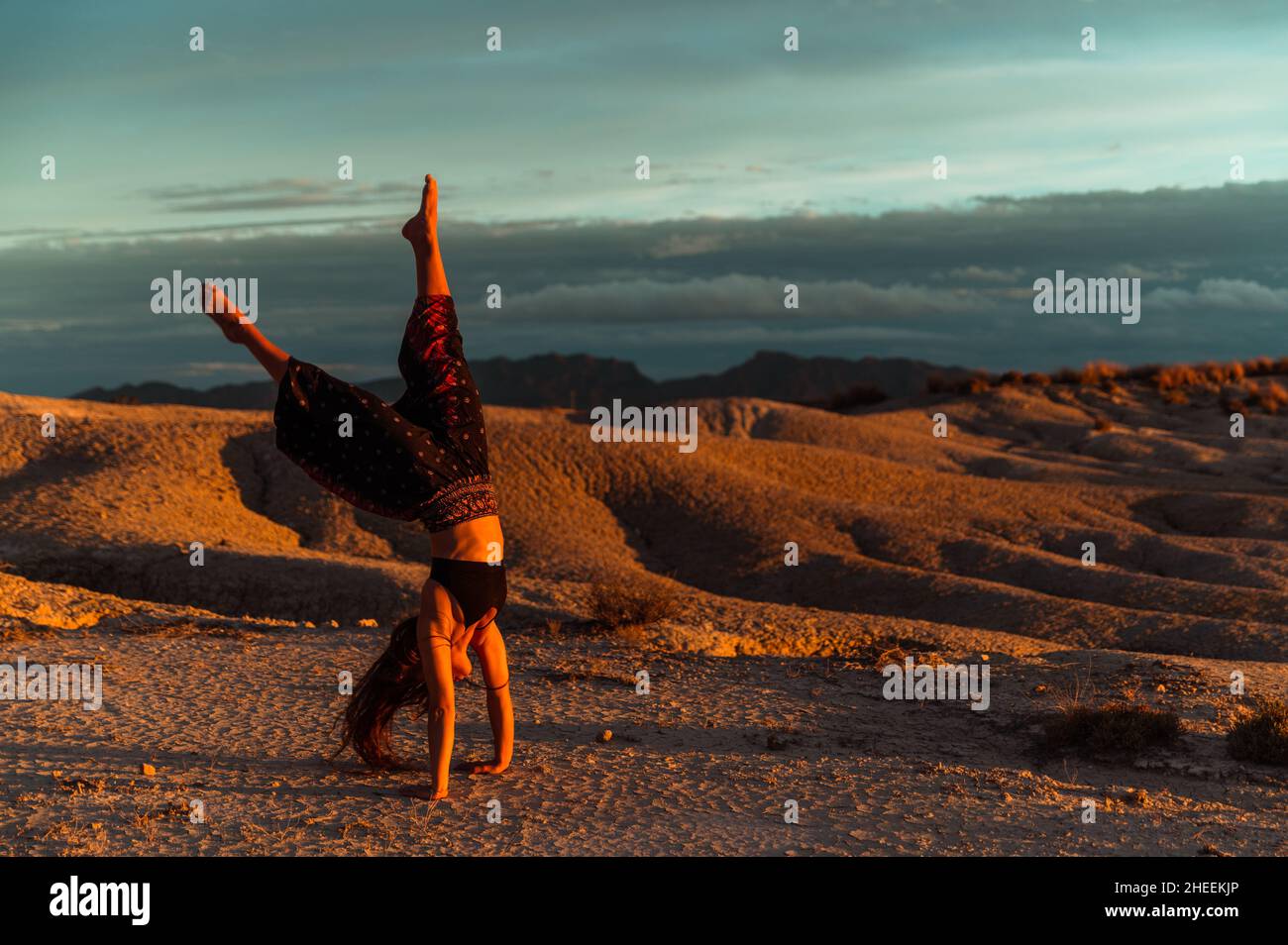 Full body of young female doing Handstand pose of Adho Mukha ...