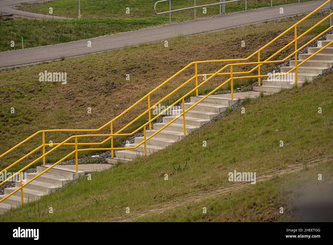 Yellow railings and stairs by a field Stock Photo - Alamy