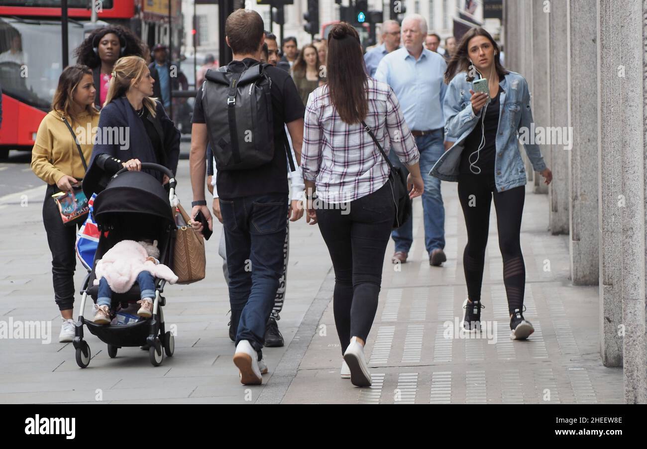 LONDON, UK - CIRCA SEPTEMBER 2019: People walking on the pavement in ...