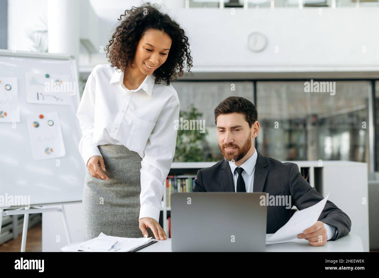 Two successful business partners of different nationalities working ...